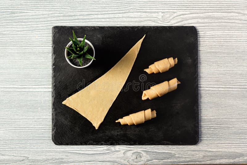 Three Uncooked Croissant-shaped Rolls, Each with a Triangular Piece of ...