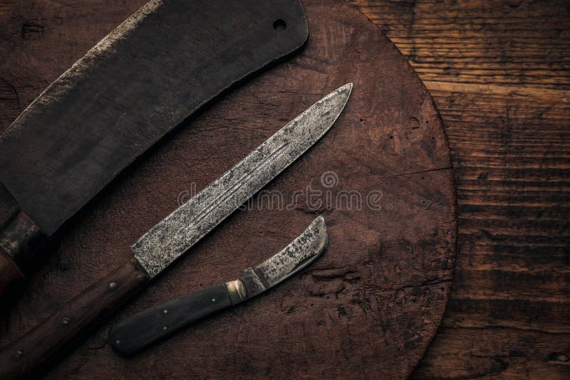 Three Vintage Meat Cutting Utensils on an Old Wood Cutting Board Stock ...