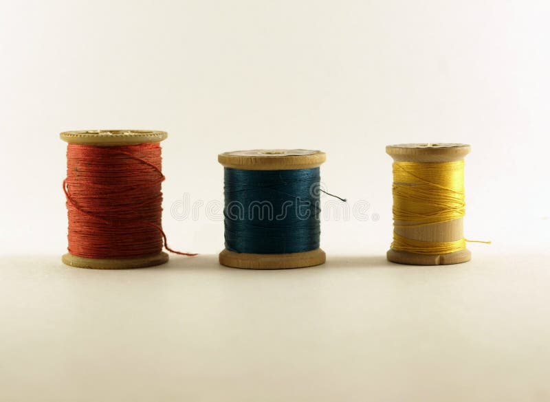 Three Vintage Wooden Thread Spools with Red, Blue and Yellow Thread ...