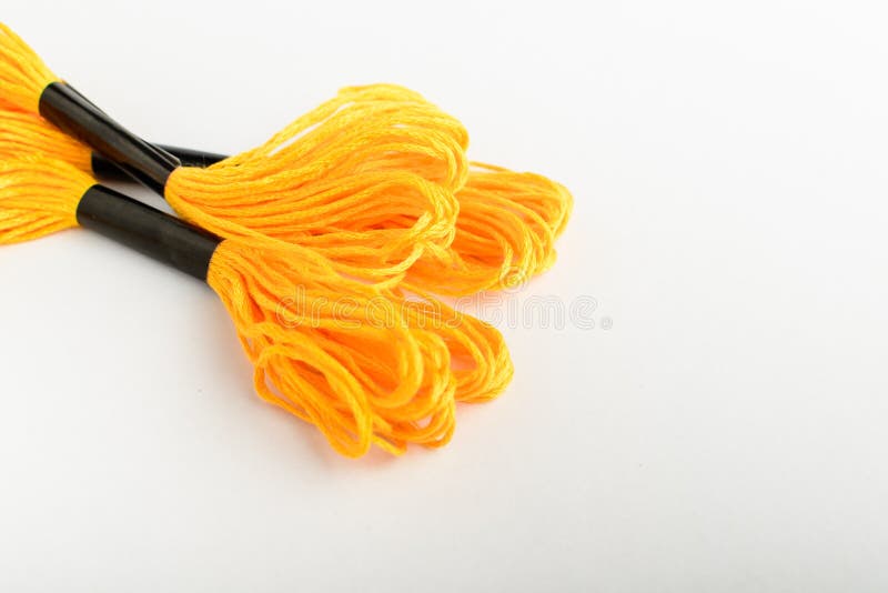 Three Vivid Yellow Sewing Threads for Embroidery Isolated on a White ...