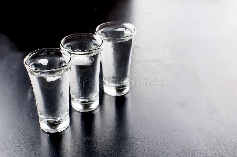 Vodka shots on black table stock photo. Image of black - 110607206