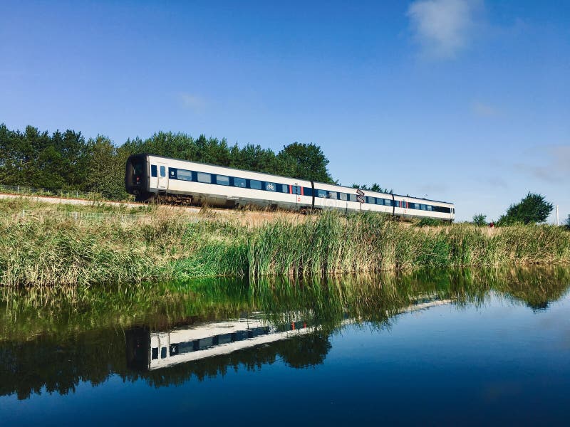 Train in Denmark by water editorial image. Image of danish - 327223030