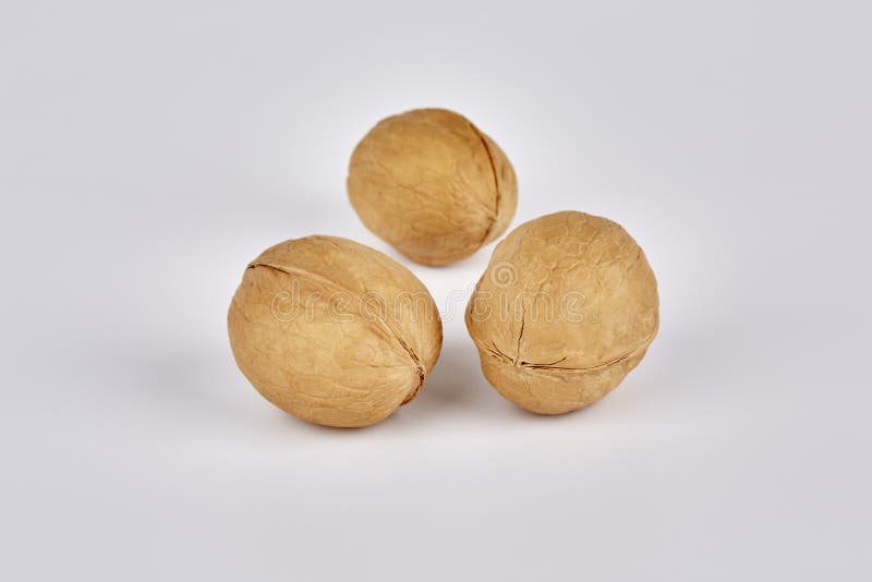 Three Walnuts on a Gray Background in the Center Stock Photo - Image of ...