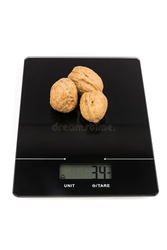 Three Walnuts in the Shell on a Digital Scale Isolated Over White Stock ...