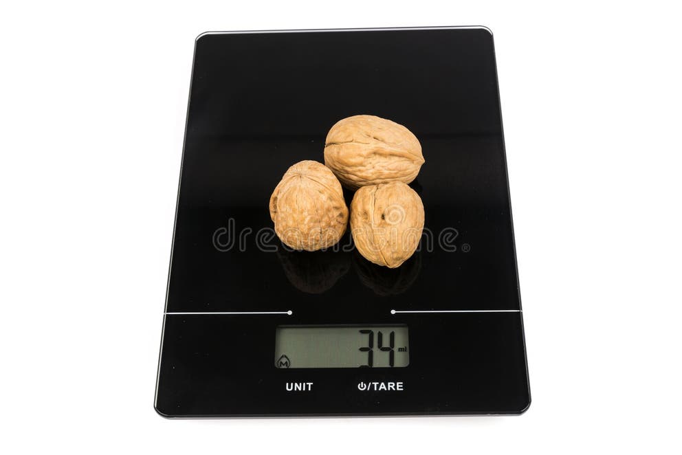 Three Walnuts in the Shell on a Digital Scale Isolated Over White Stock ...