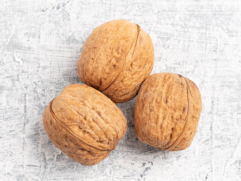 Three Walnuts on White Concrete Background Stock Image - Image of table ...