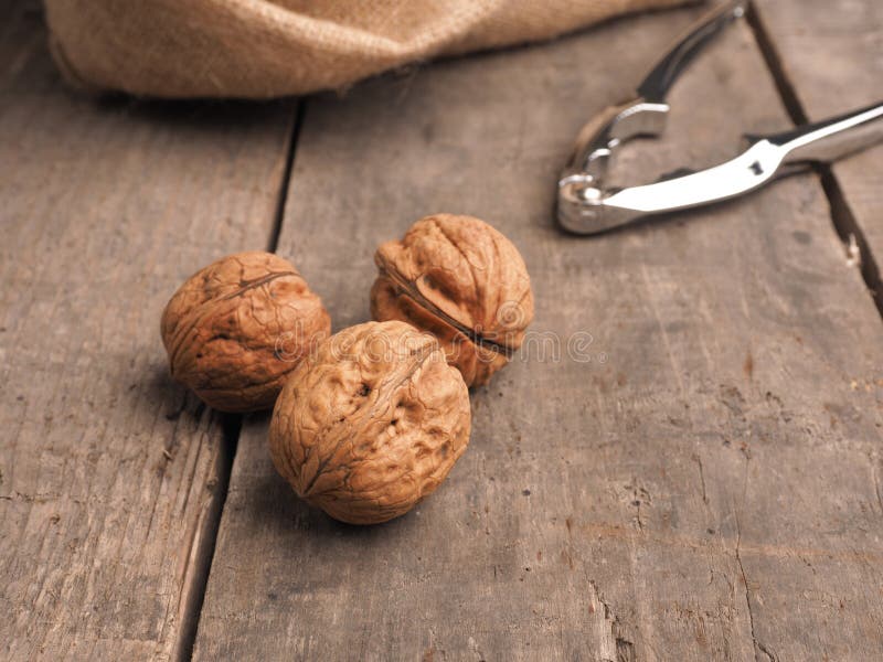 Three Walnuts on a Wooden Table Stock Photo - Image of food, health ...