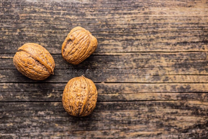 Three Walnuts on Wooden Table. Top View Stock Photo - Image of wooden ...