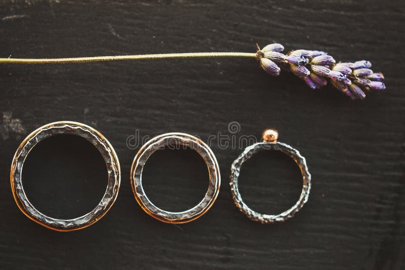 Three Wedding Rings on a Table with a Branch of Lavender Stock Image ...