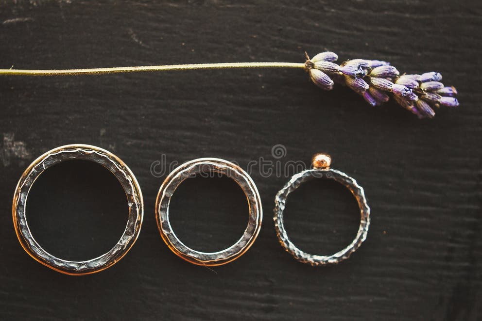 Three Wedding Rings on a Table with a Branch of Lavender Stock Image ...