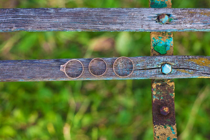 Three Wedding Rings on a Wooden Floor Stock Image - Image of join ...