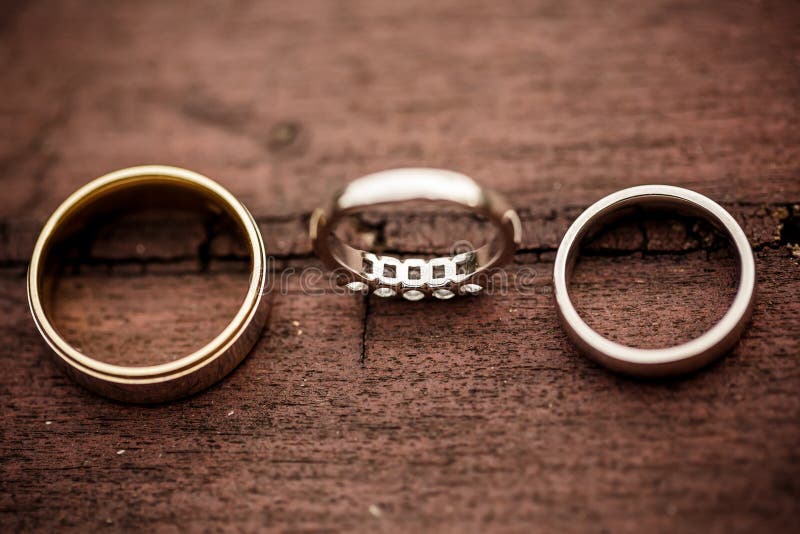 Three Wedding Rings on Wooden Floor Stock Photo - Image of eternity ...