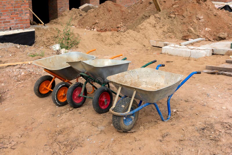 Three Wheelbarrows without People on the Construction Site ...