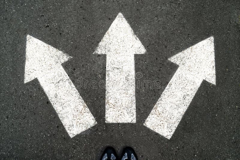 Man Standing on Road with Many Direction Arrow Choices or Move Stock ...