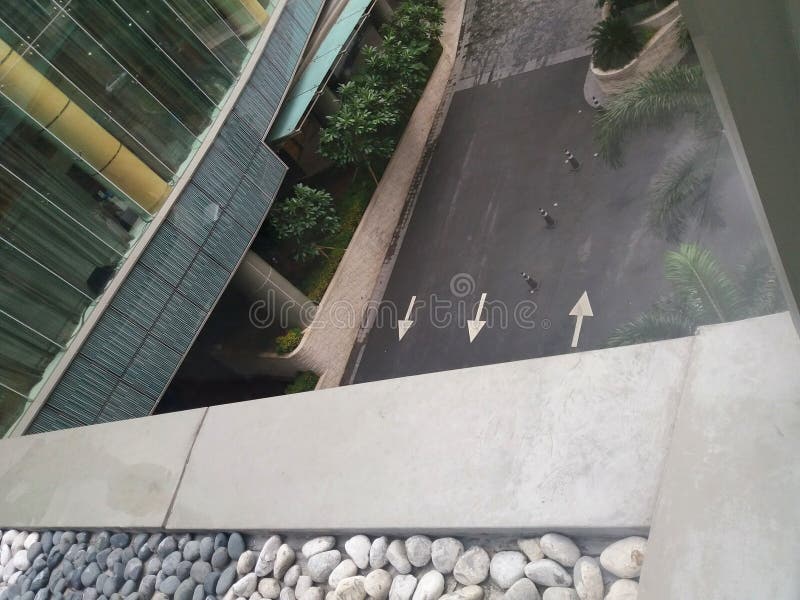 Three White Arrows on a Street Viewed from Second Floor Balcony with ...