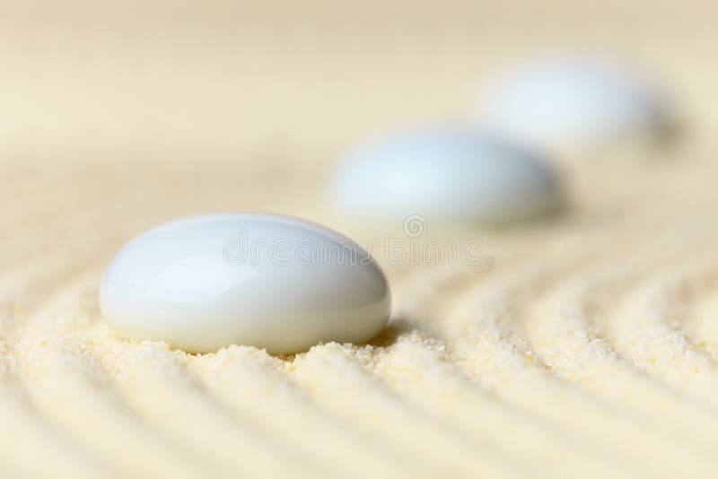 Three White Drops on Surface of Yellow Sand Stock Photo - Image of ...