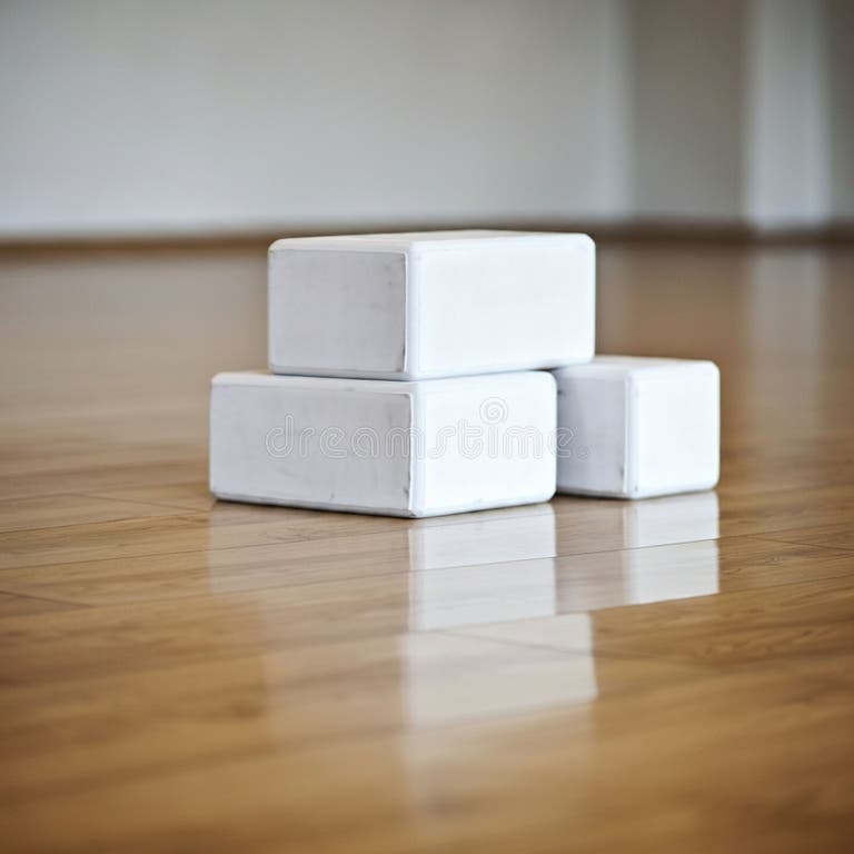 Three White Rectangular Yoga Blocks are Stacked on a Polished Wooden ...