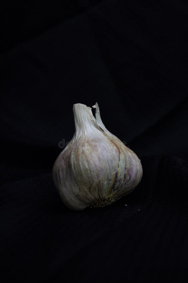 Three Whole Garlic Bulbs Grouped on Black Stone Plate Stock Photo ...