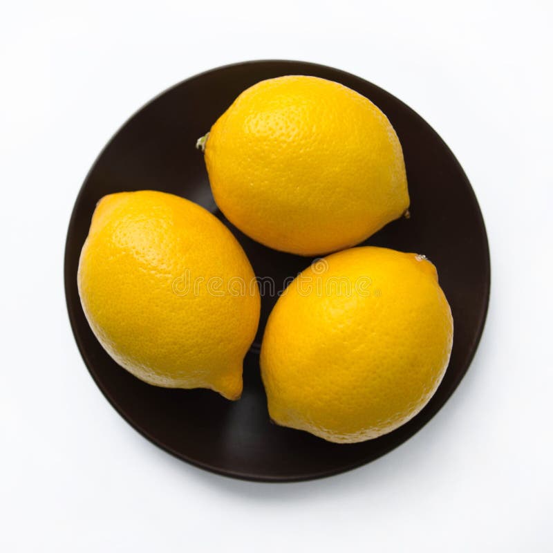 Three Lemons on a plate stock photo. Image of kitchen - 127624972