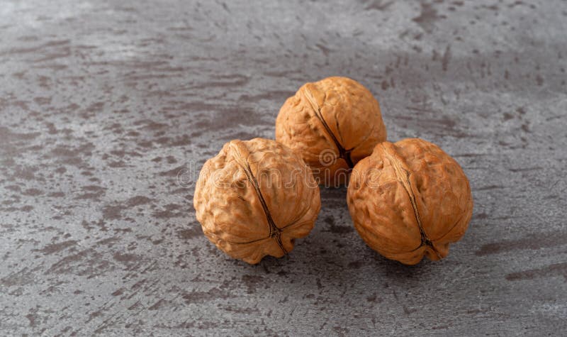 Three Whole Walnuts on a Gray Background Stock Photo - Image of snack ...
