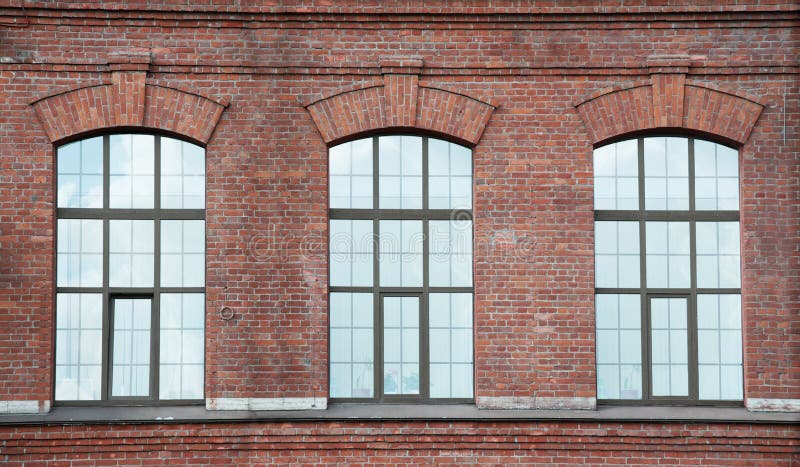 Three Window on a Red Brick Wall Stock Photo - Image of building ...