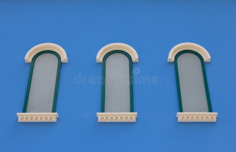 Three windows on blue wall stock photo. Image of city - 32332022