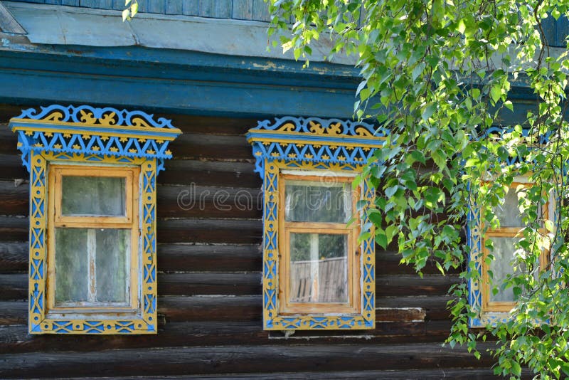 Three Windows with Carved Platbands Behind Birch Branches Stock Image ...
