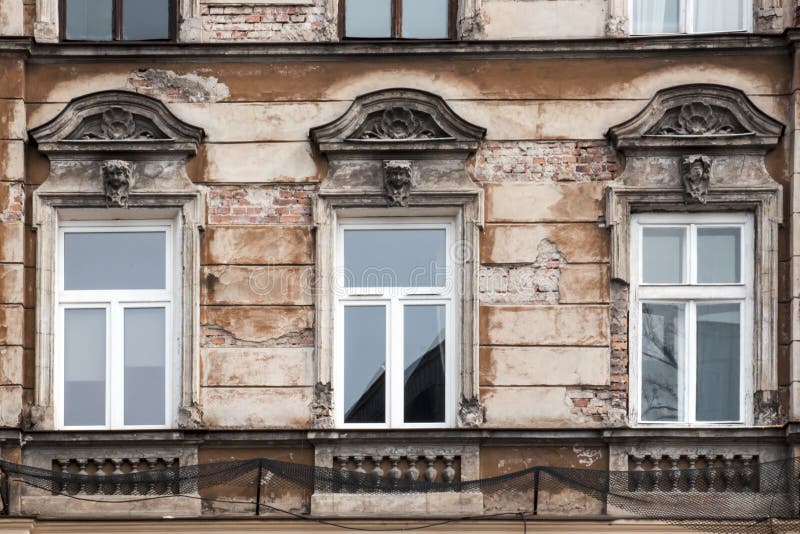 Three Windows on the Facade of the Old Shabby House Stock Photo - Image ...