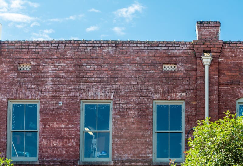 Three Windows in Old Brick Building Stock Photo - Image of facade ...