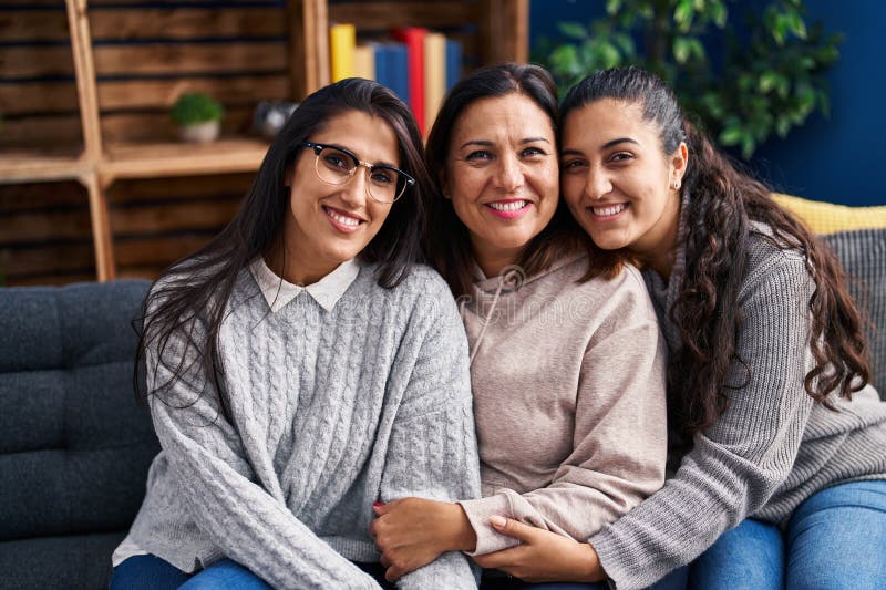 Three Woman Hugging Each Other Sitting on Sofa at Home Stock Photo ...
