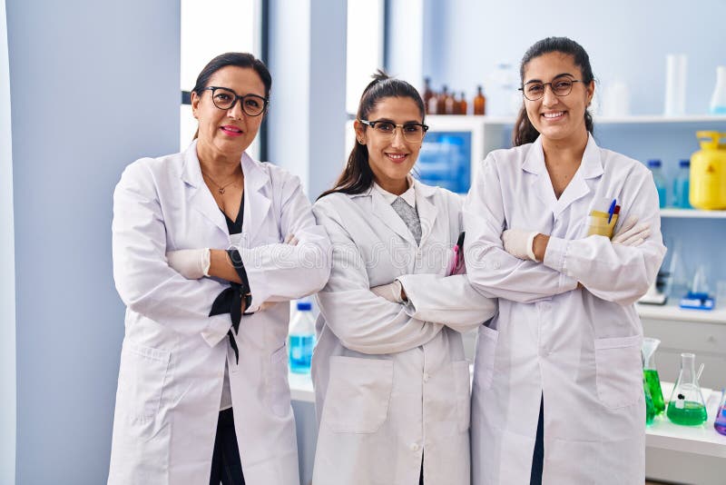 Three Woman Scientists Standing with Arms Crossed Gesture at Laboratory ...