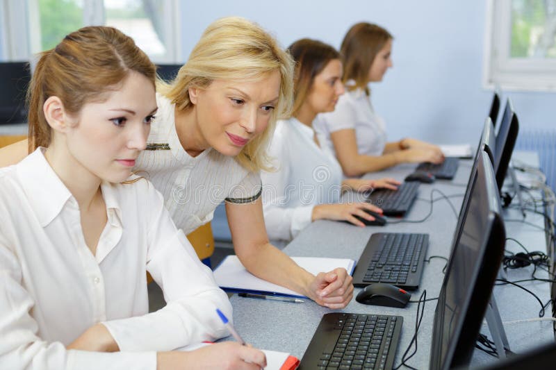 Three women in classroom stock image. Image of sitting - 335183631