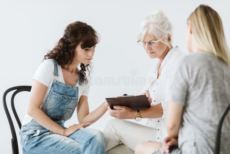 Three women discussing stock image. Image of overalls - 156382969