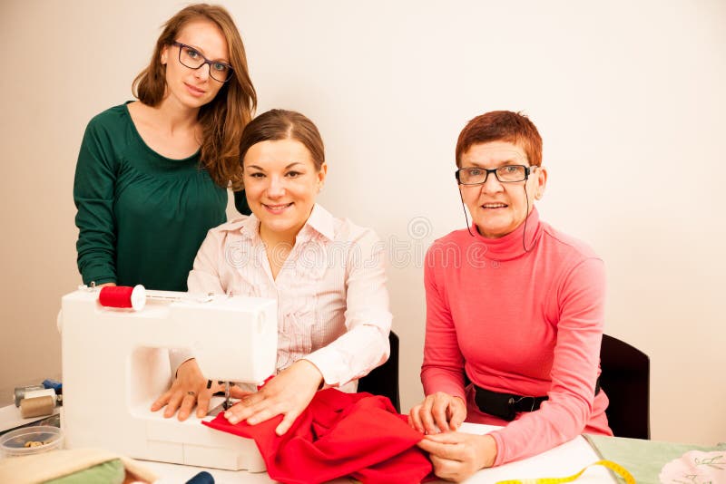 Three Women are Sewing on Handcraft Workshop. they are Teaching Stock ...
