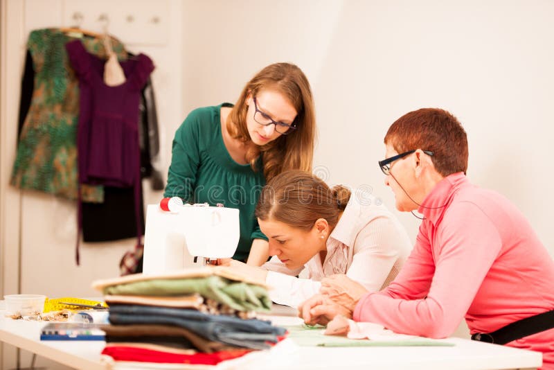 Three Women are Sewing on Handcraft Workshop. they are Teaching Stock ...