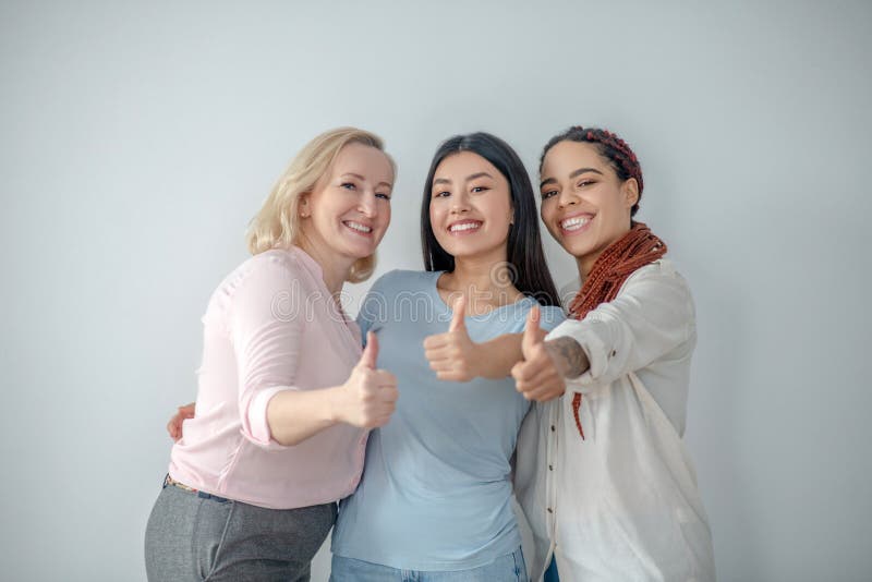 Three Women Standing Near the Wall Smiling Stock Photo - Image of room ...