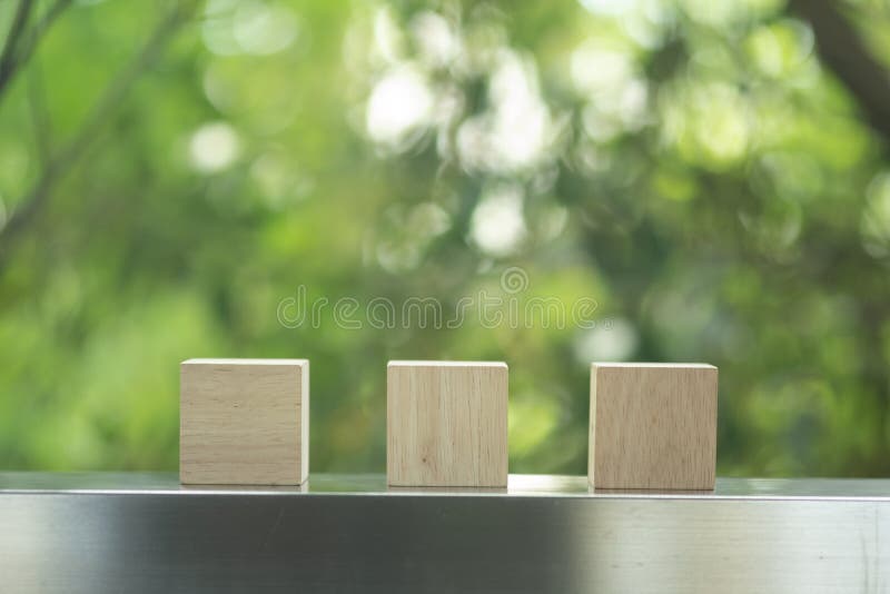 Three of Wood Blocks Against Nature Background Stock Photo - Image of ...