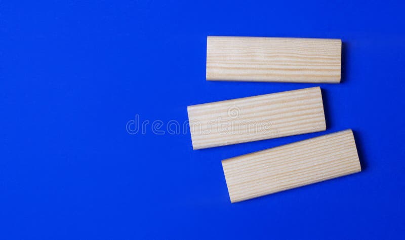 Three Wooden Blocks with Space To Insert Text on a Blue Background ... Three Wooden Blocks with Space To Insert Text on a Blue Background ...