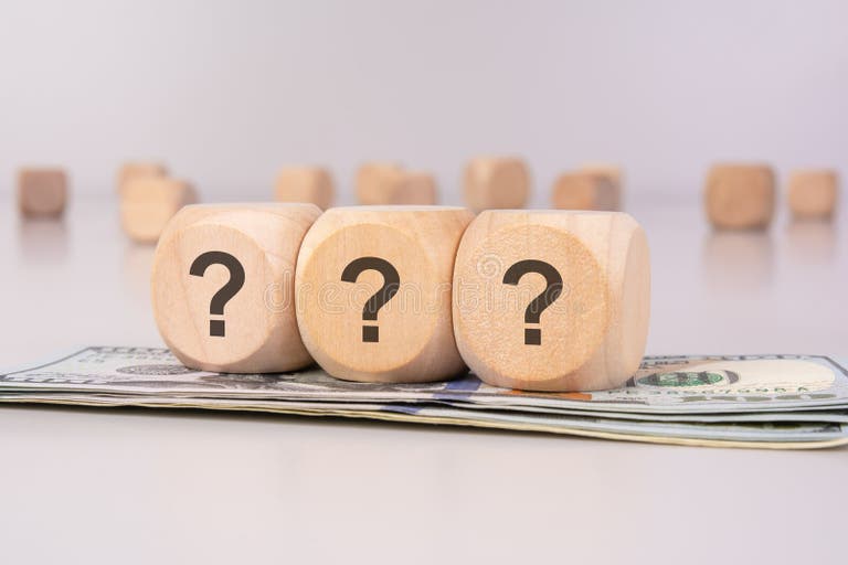 Three Wooden Blocks with Question Marks on Dollar Bills, Symbolizing ...