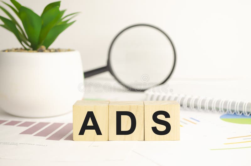 Three Wooden Cubes with Letters - ADS - Advertisements, on Yellow Table ...