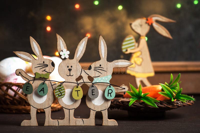 Three Wooden Easter Bunnies with Easter Eggs Stock Image - Image of ...