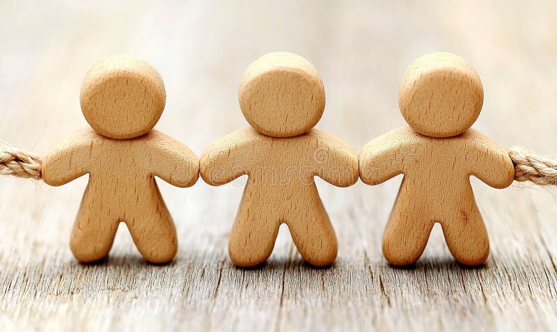 Three Wooden Figures Holding Hands Connected by String on a Wooden ...