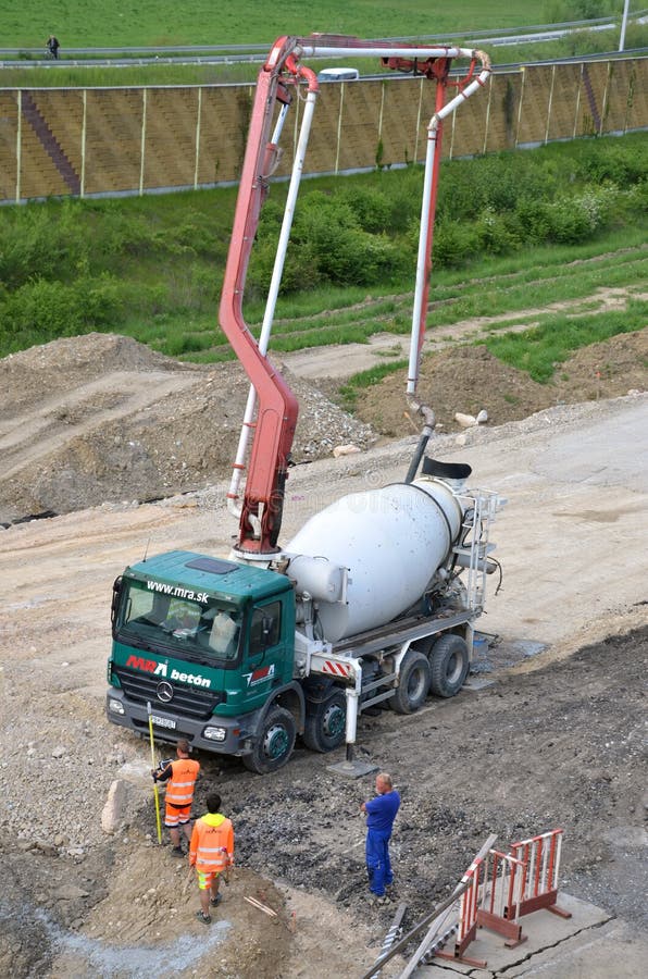 Three Workers and Concrete Transport Truck with Concrete Pump Ready for ...