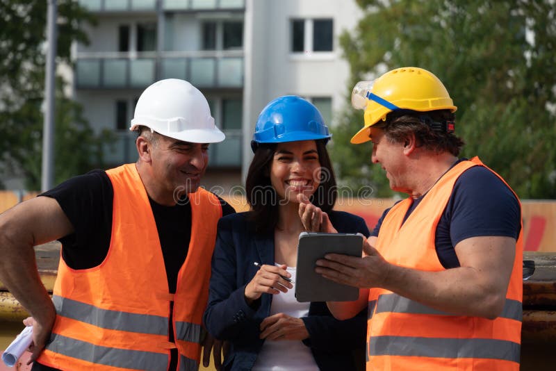 Three Workers on Construction Site Stock Photo - Image of clothing ...