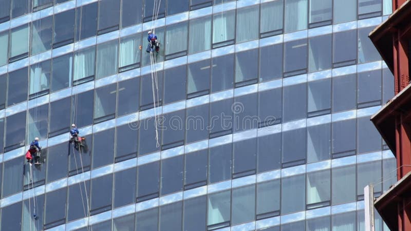Three Workers Hang on Ropes and Wash Windows of Stock Video - Video of ...