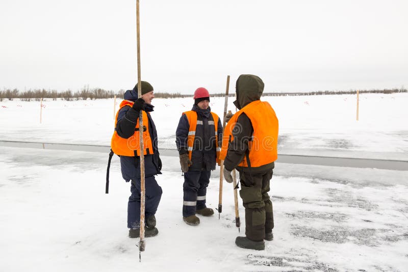 Three Workers on the Ice of a Frozen Pond Stock Image - Image of city ...