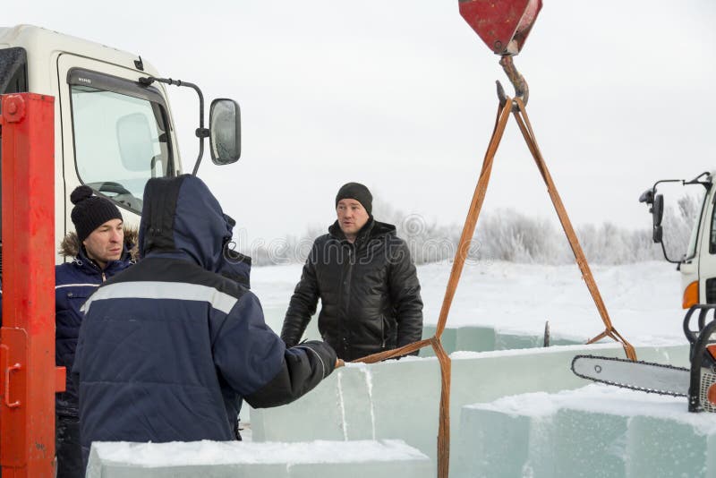 Three Workers Prepare Ice Panels for the Ice Town for Loading Stock ...