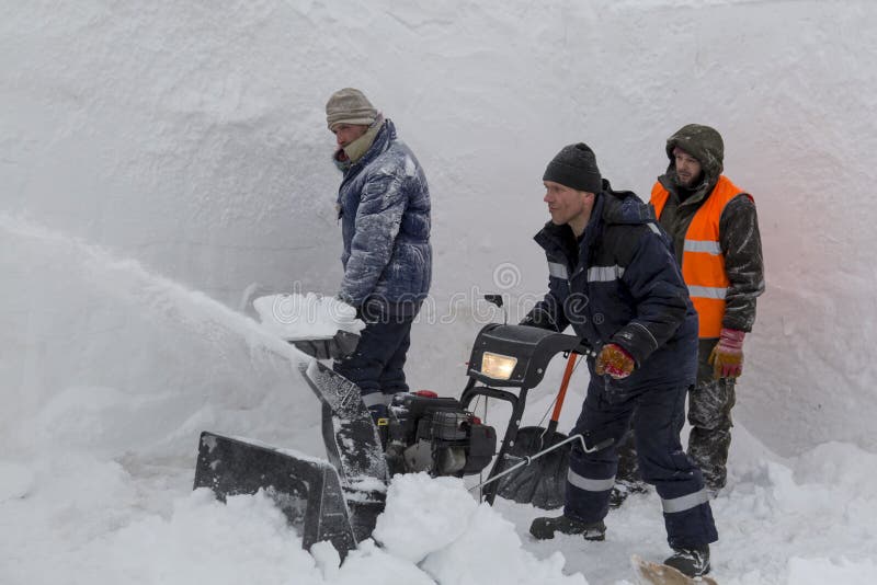 Three Workers in a Snowstorm during Snow Removal Stock Photo - Image of ...