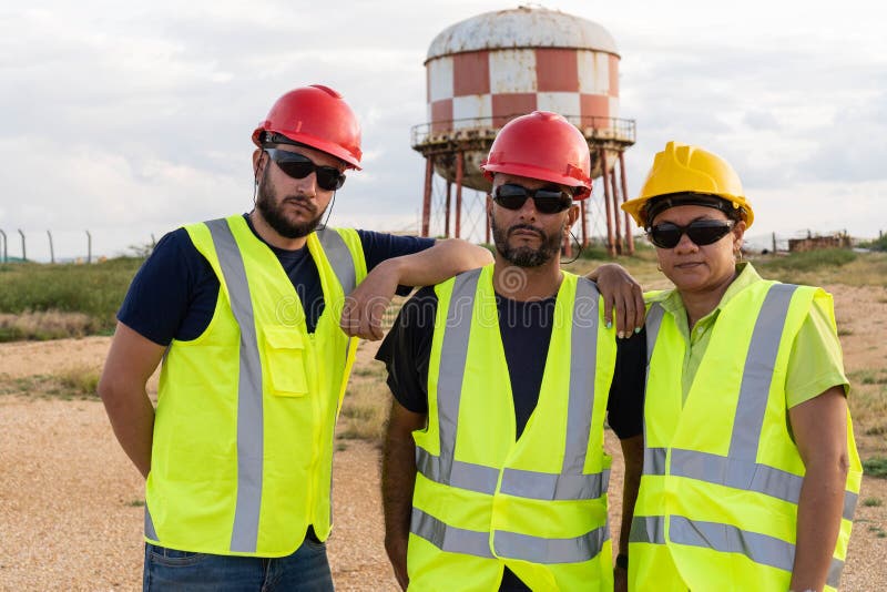 Three Workers Standing on the Construction Site Stock Image - Image of ...