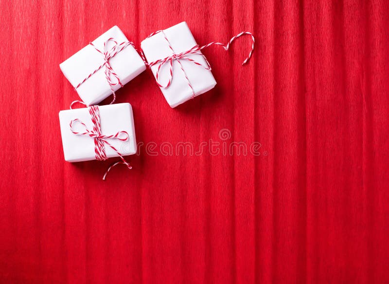 Three Wrapped Presents with Red Ribbon on Them are Stacked on Top of ...
